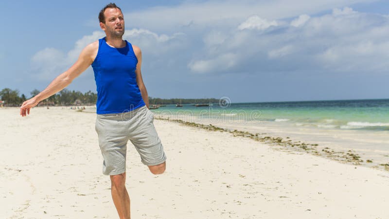 Man Exercising on Beach. he is Stretching. Stock Photo - Image of ...