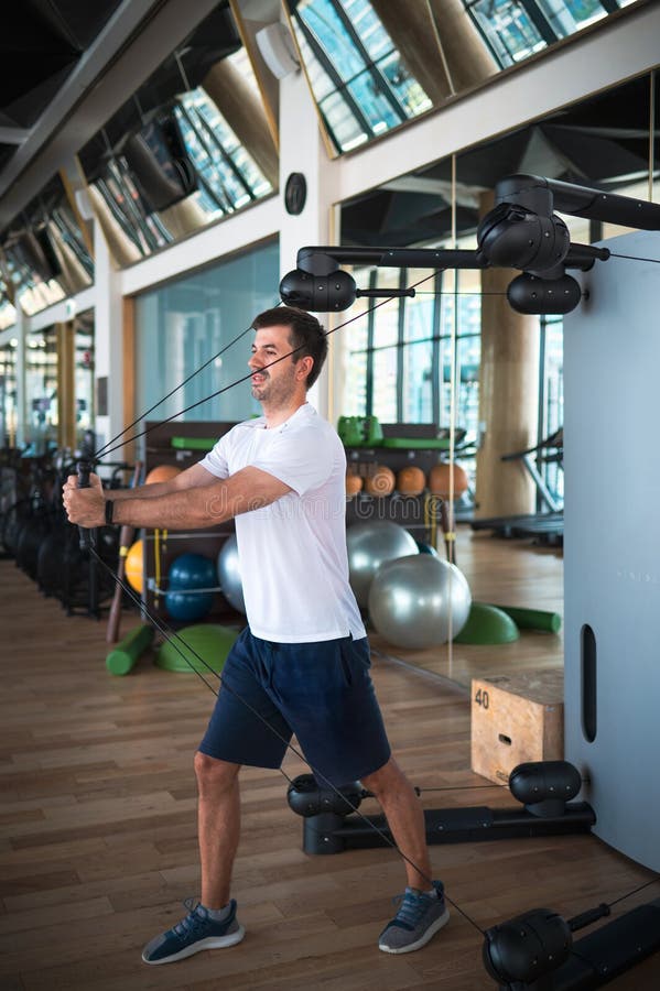 Man Exercising in the Gym on a Pec Deck Machine for Chest Workout Stock ...