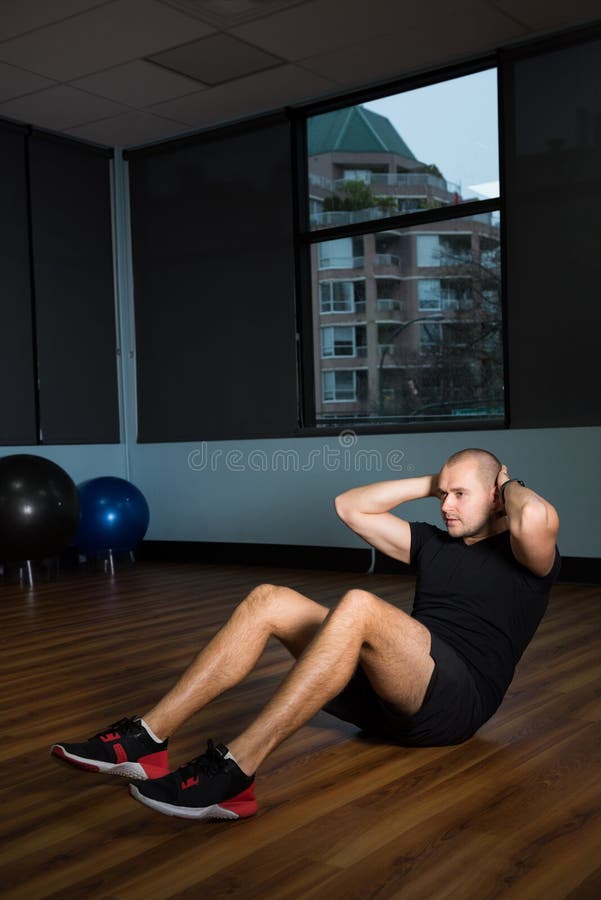 Man Exercising on Hardwood Floor at Gym Stock Photo - Image of exercise ...