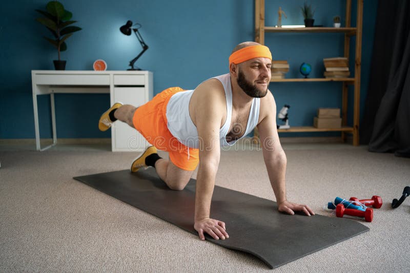 Man Exercising at Home on Yoga Mat Doing Leg Lift Exercise Stock Image ...