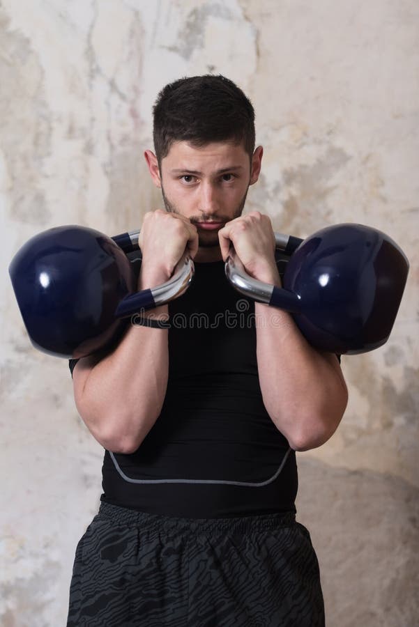 Man Exercising with Kettle Bell Stock Photo - Image of clothing, cross ...