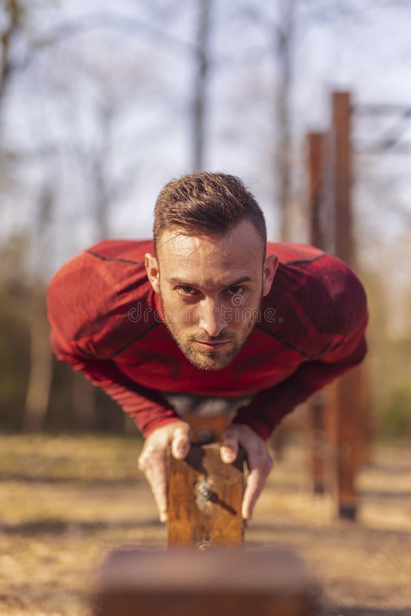Man Doing Pull Ups while Working Out in Street Workout Park Stock Photo ...