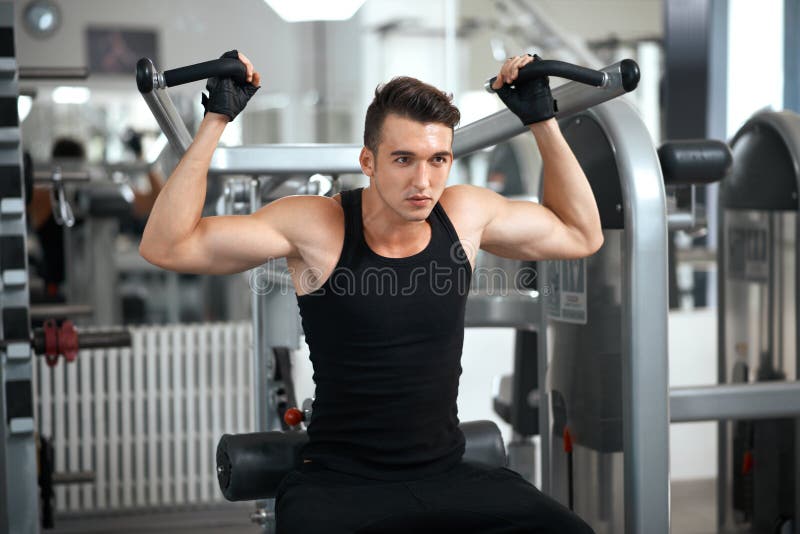 Man Exercising in Trainer for Pectoral Muscles Stock Photo - Image of ...