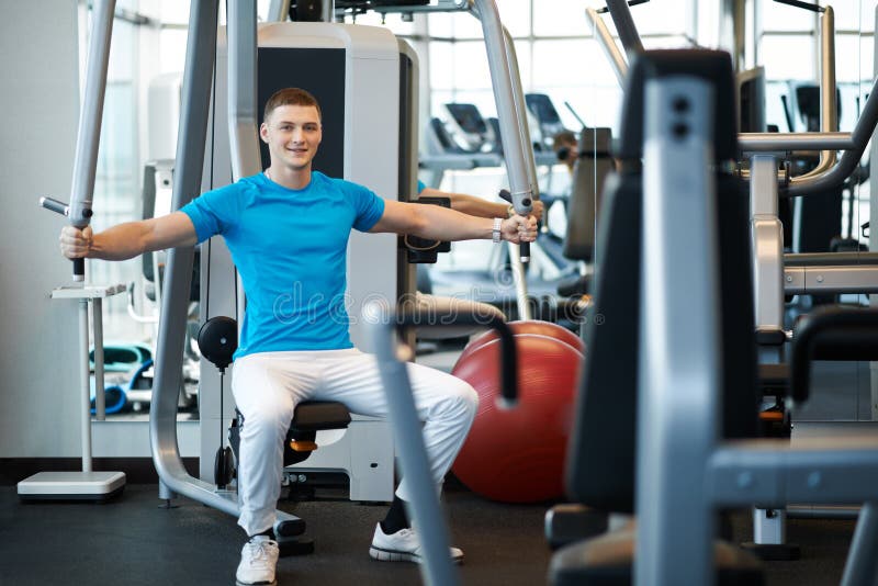 Man Exercising in Trainer for Pectoral Muscles Stock Photo - Image of ...