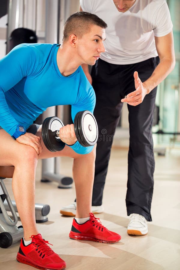 Man Exercising Under Supervision Trainer Stock Image - Image of heavy ...