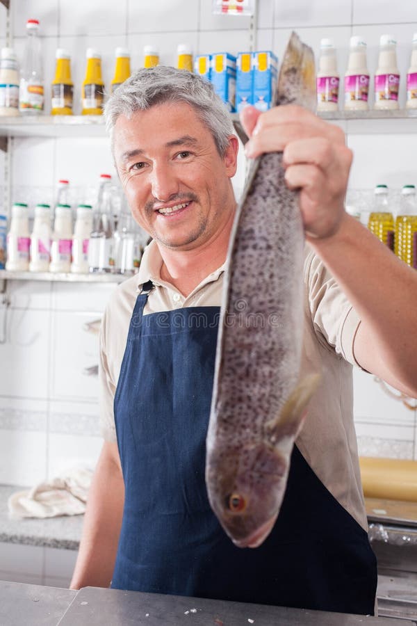 Man exhibiting a fish stock photo. Image of seller, hold - 65090066