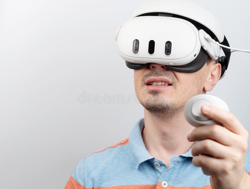 Man Experiences Virtual Reality in Bright Indoor Setting while Holding ...