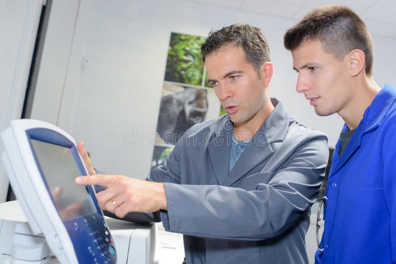 Man Explaining Controls Machine To Apprentice Stock Photo - Image of ...