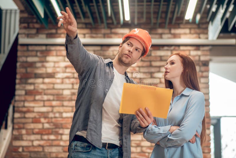 Man Explaining Showing Construction Plan To Woman Stock Photo - Image ...