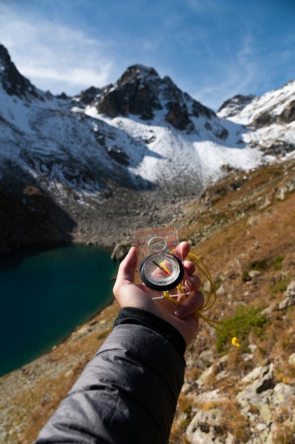 Man Explorer Looking for Direction with Compass in Summer Mountains ...