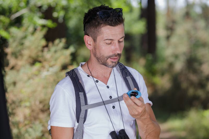 Man Explorer Searching Direction with Compass in Summer Stock Photo ...