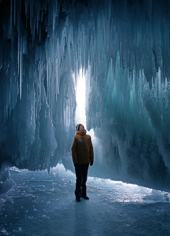 Man exploring ice cave stock photo. Image of tourist - 143157690