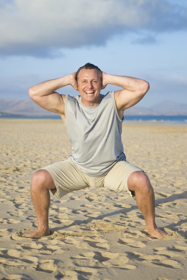 Man exrcising on beach. stock image. Image of physical - 9902059