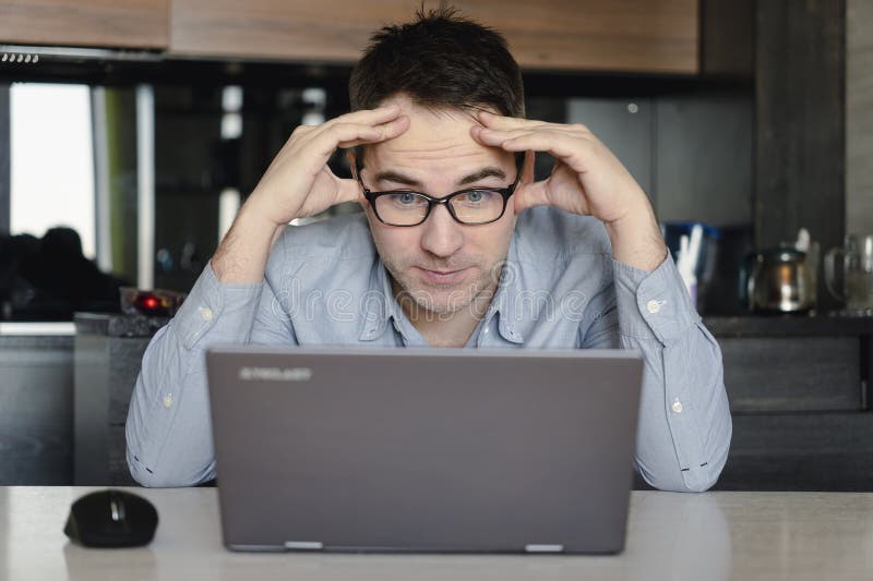 Man in Eyeglasses Holding Laptop and Looking Extremely Perplexed on ...