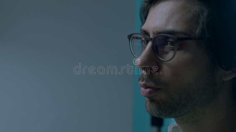 Close-up of a Coder Wearing Eyeglasses at Night, with Reflections of ...