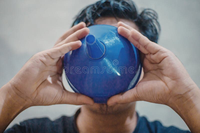 A Man with a Face Covered in a Blue Funnel Stock Photo - Image of nose ...