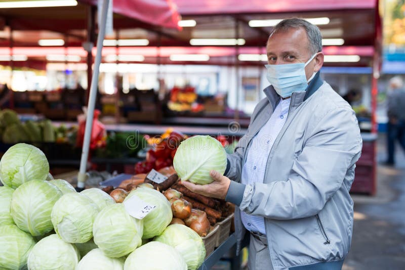 Man in Face Mask Choosing Cabbage in Market Stock Photo - Image of ...