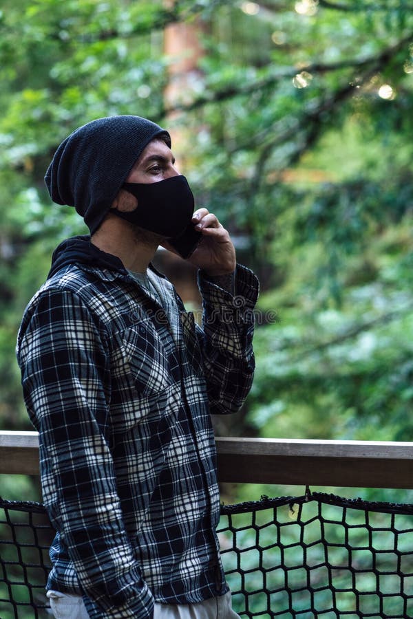 Man with Face Mask Talking on the Phone on a Natural Environment ...