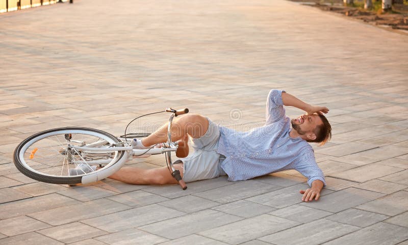 Man fallen off his bicycle stock image. Image of accident - 125943221