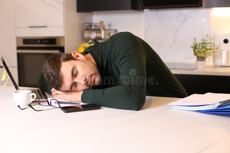 Man Falling Sleep while Working Remotely from His Kitchen Stock Image ...