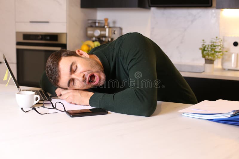 Man Falling Sleep while Working Remotely from His Kitchen Stock Image ...