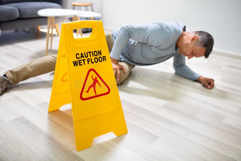 Man Falling on Wet Floor in Front of Caution Sign Stock Photo - Image ...