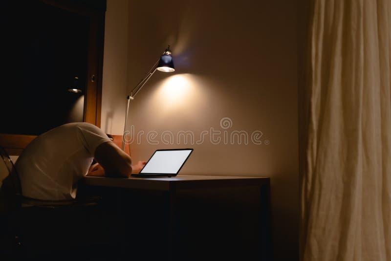 Man Falls Asleep while Doing Work on the Desk with a Laptop at Night ...