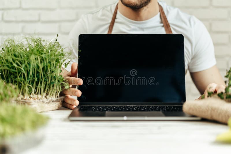 Man Farmer Shows Black Screen of Laptop and Sits at the Table with ...
