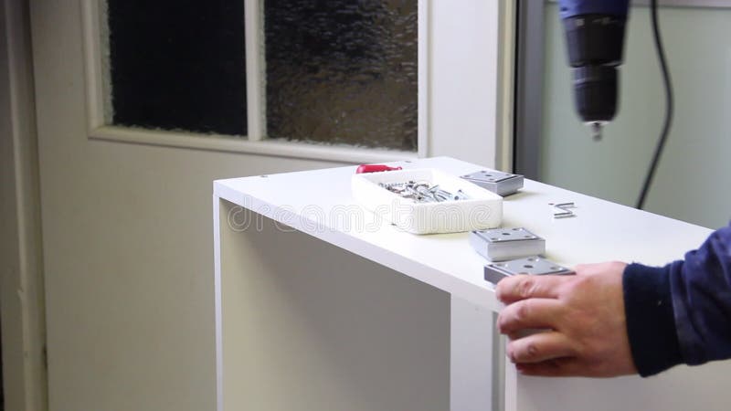 The Man Fastens the Support To the Bottom of the Rack. Wooden Modular ...