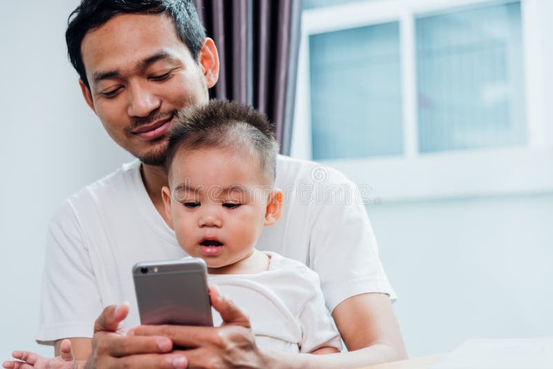 Man Father Working on Laptop Computer and Using Smartphone Technology ...