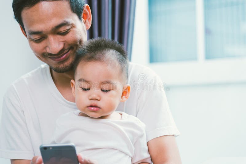 Man Father Working on Laptop Computer and Using Smartphone Technology ...