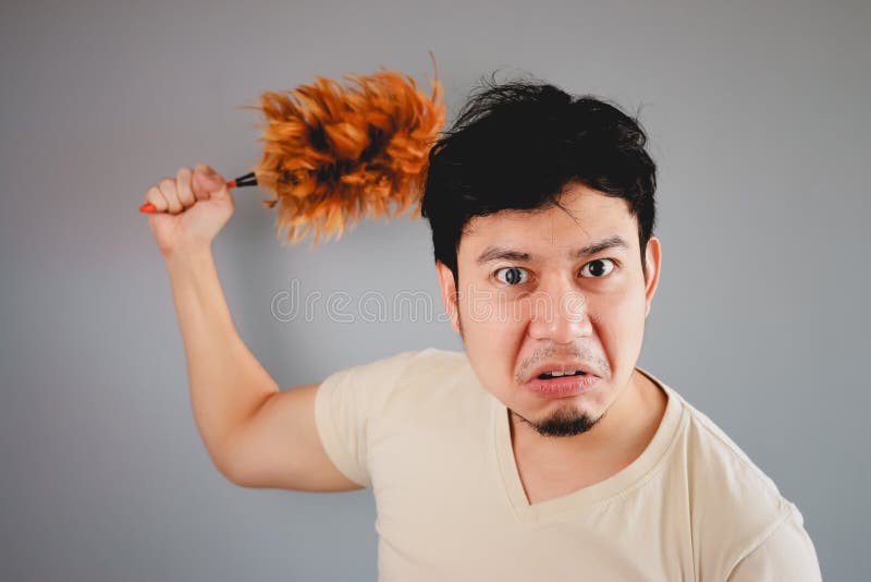 Man and feather duster. stock photo. Image of company - 59505228