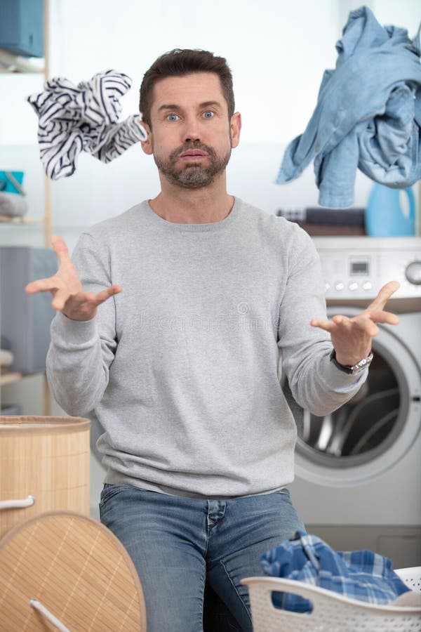 Man fed up doing laundry stock photo. Image of people - 288155474