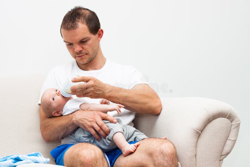 Man feeding infant stock image. Image of family, bottle - 29109481