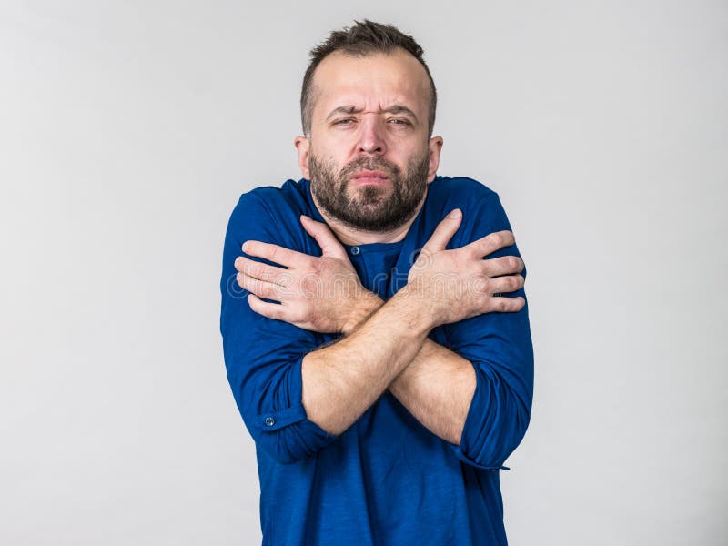 Man feeling cold gesturing stock image. Image of shivering - 160452105