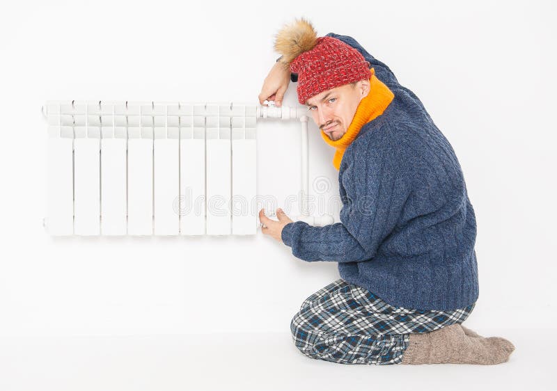 Man Feeling Cold in Hat and Blue Pullover Sitting Close To Radiator ...