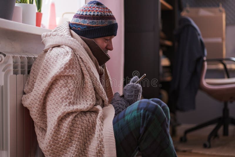 Man Feeling Cold at Home Having Problems with Home Heating Sitting with ...