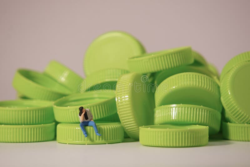 Man Figure Siting on Plastic Cap. Recycle Material Concept Stock Photo ...