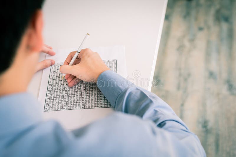 Man Filling Out an Answer on Answer Sheet Stock Photo - Image of school ...