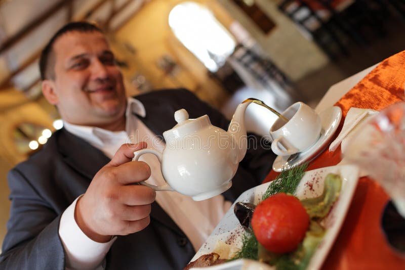 Man fills cup of tea stock photo. Image of breakfast - 19415436