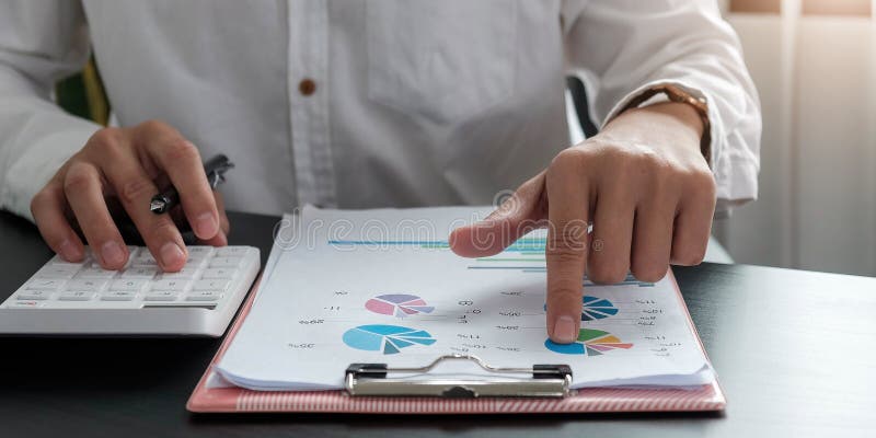 Man with Financial Report and Calculator. Man Using Calculator To ...