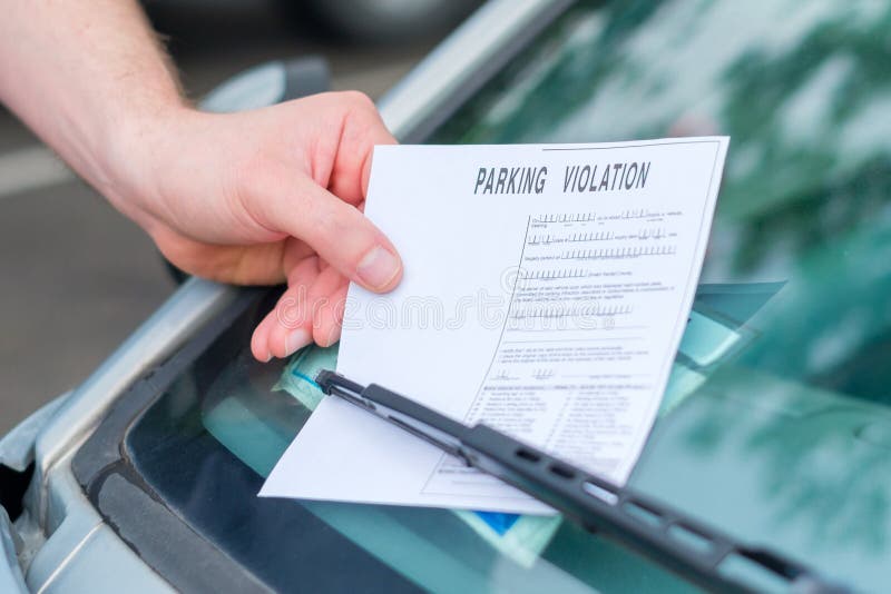 Man Finding a Ticket Fine Under the Car Windscreen because of Parking ...