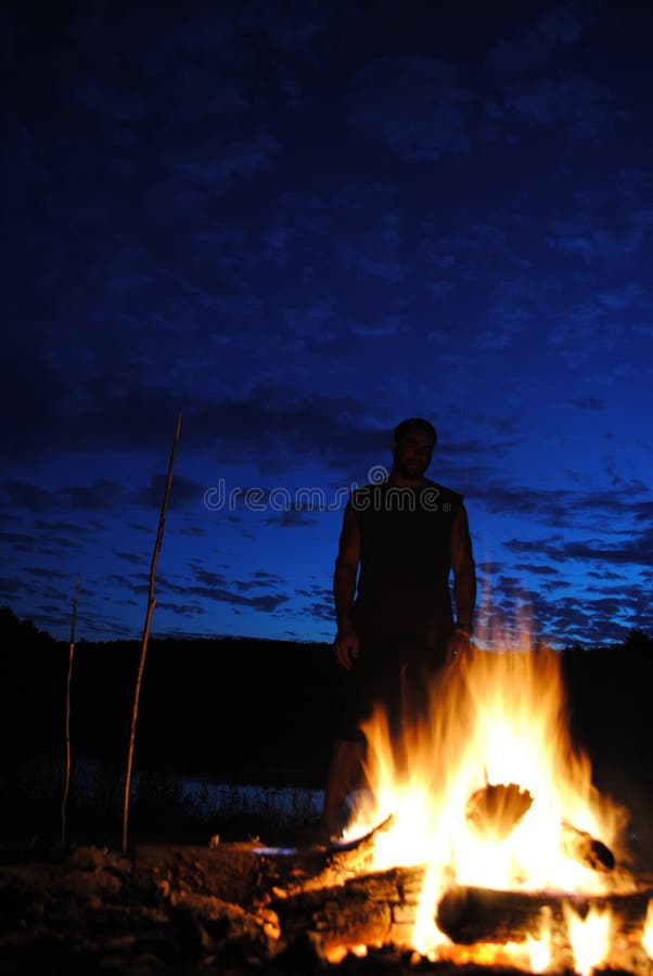 Man by Fire stock image. Image of shorts, grass, wood - 20387145