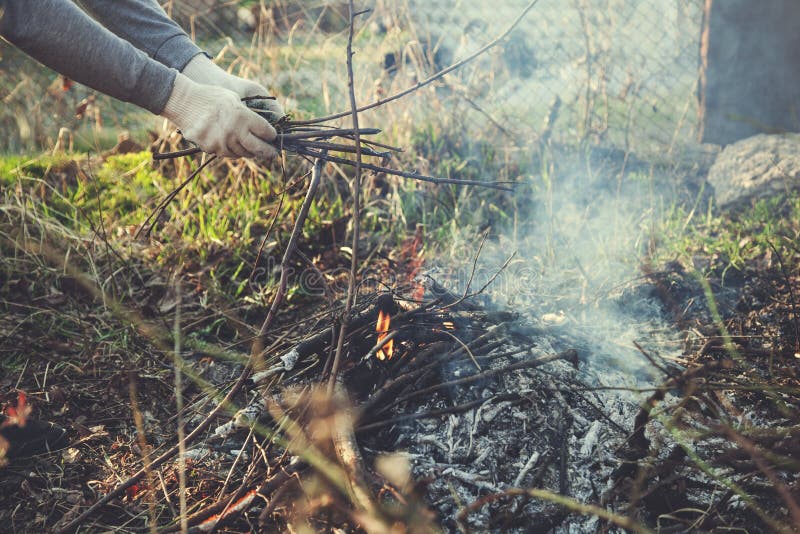 Man with fire in garden stock photo. Image of lawn, pruning - 142718782
