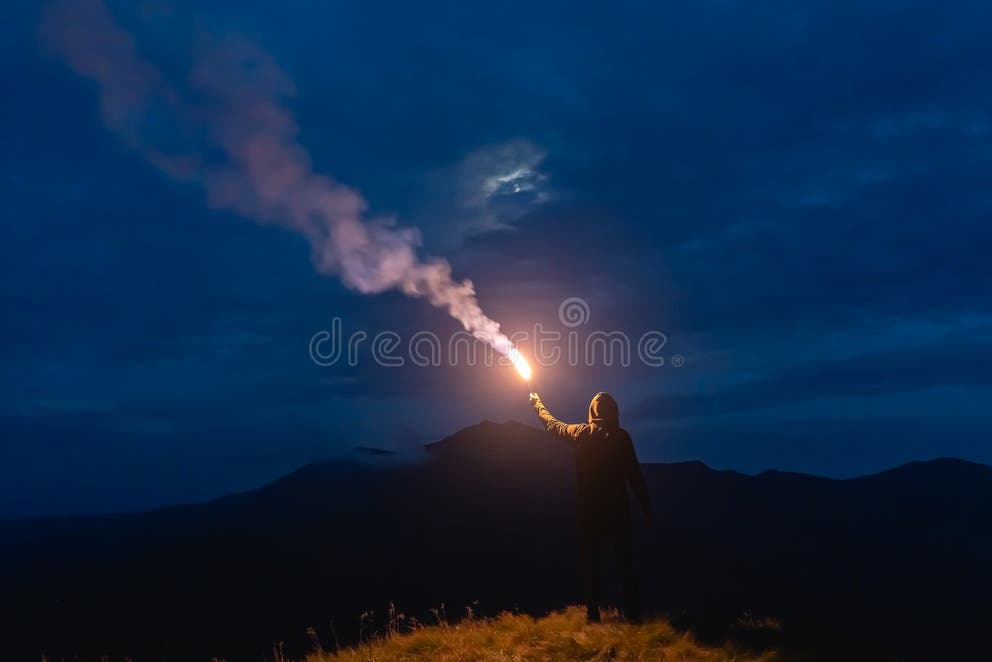 The Man with a Firework Stick Standing on a Mountain. Stock Image ...