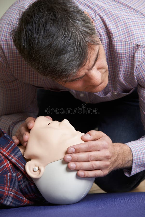 Man in First Aid Class Checking Airway on CPR Dummy Stock Image - Image ...