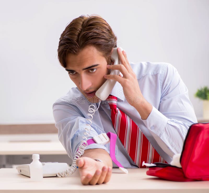 Man with First Aid Kit in the Office Stock Photo - Image of phone, desk ...
