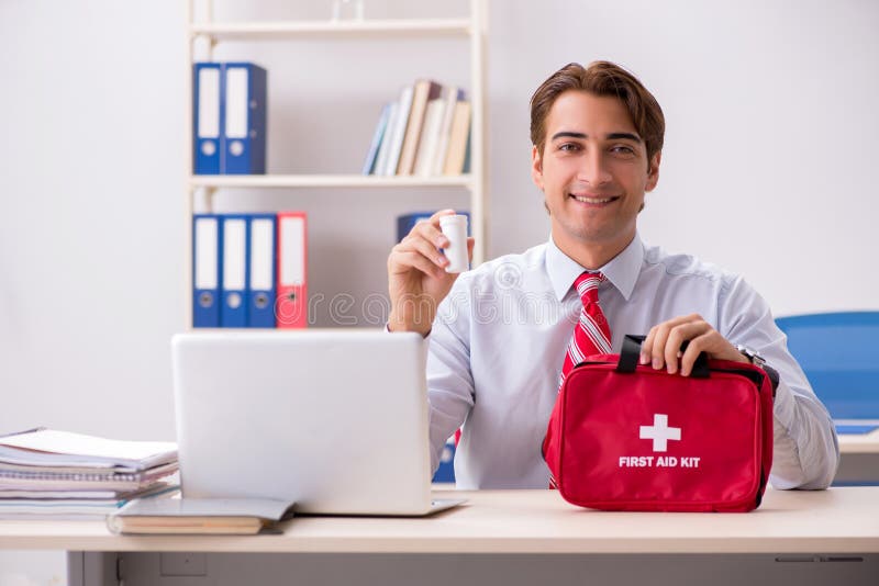 The Man with First Aid Kit in the Office Stock Photo - Image of happy ...
