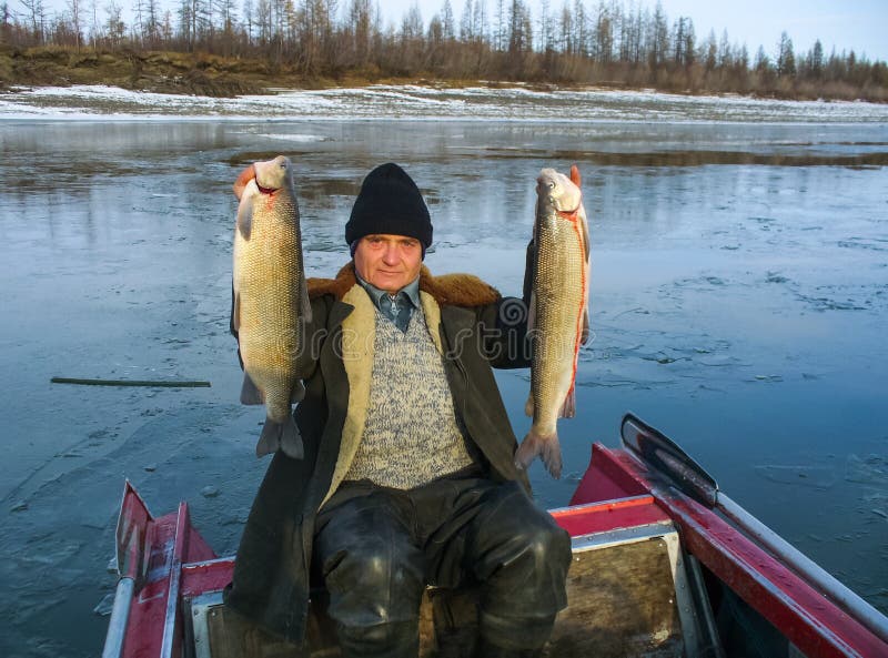 Man with a Fish Catch on a Boat. Wild Fishing on the River. Editorial ...