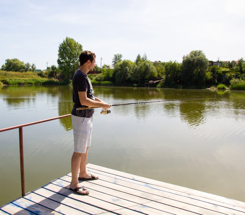 Man Fishing from the Bridge Stock Photo - Image of leisure, person ...